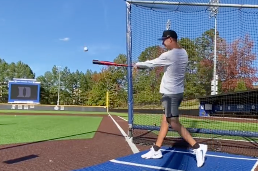 Duke basketball coach Jon Scheyer shows off during batting practice ...