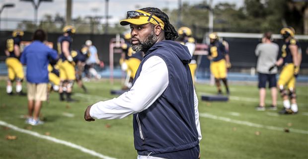 Devin Bush Sr. coaching for a job position during bowl practice