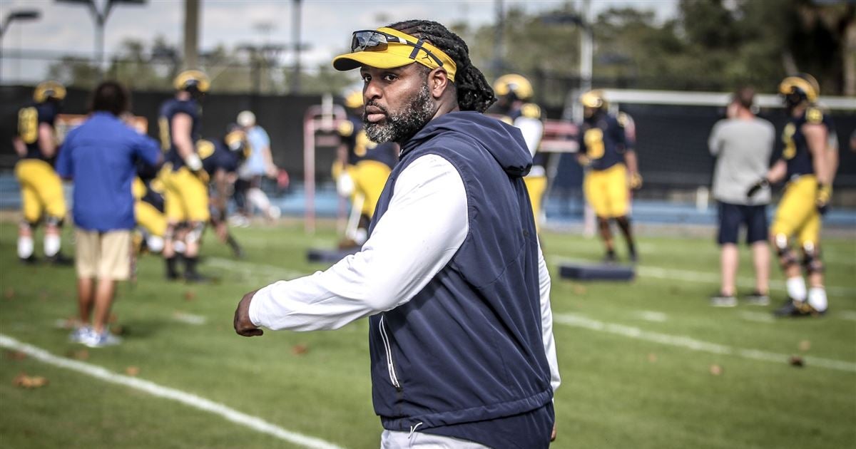Devin Bush Sr. coaching for a job position during bowl practice