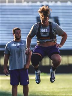 Trey Adams works out as players come back for summer training