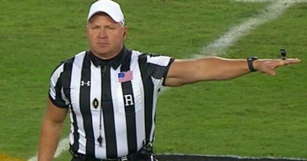 College Football Playoff referee's arms steal show in first half