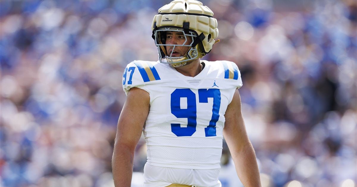 UCLA running back Cameron Jones and defensive end Jacob Busic entering ...