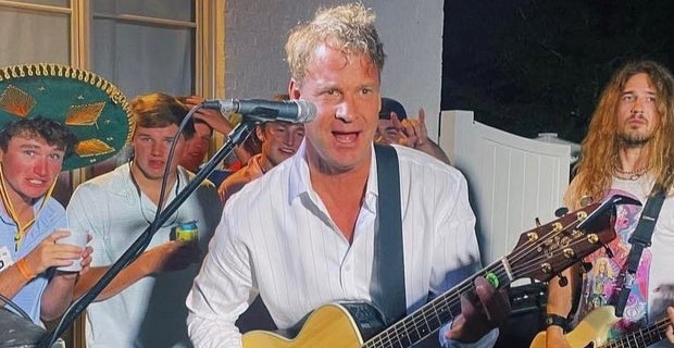 Ole Miss head coach Lane Kiffin rocks it out at daughter's graduation party