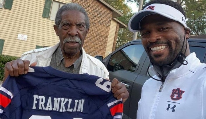 Travis Williams surprises Dr. Harold Franklin with Auburn jersey