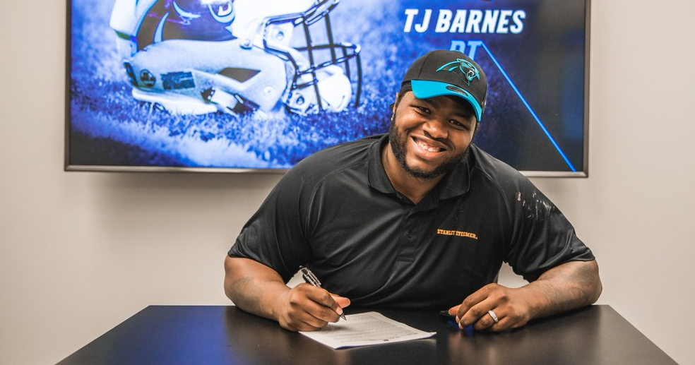 T.J. Barnes signs Panthers contract in Stanley Steemer outfit